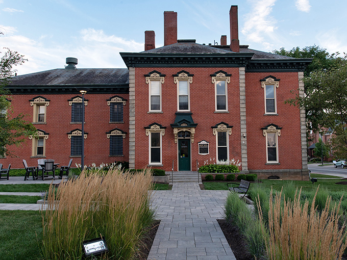 This stately brick building with ornate window details showcases the craftsmanship of another era, when buildings were designed to impress for generations.