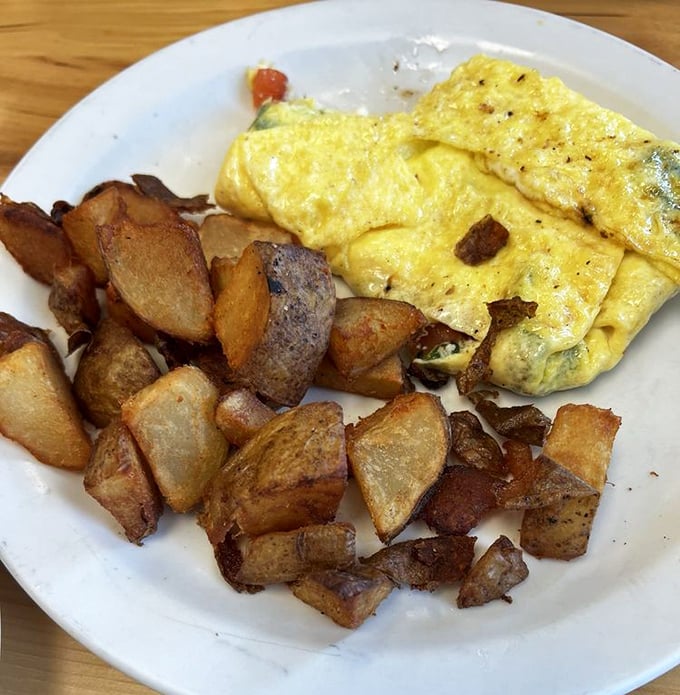 Home fries that achieve the culinary holy grail&mdash;crispy exterior, fluffy interior&mdash;paired with an omelet that's practically floating off the plate.