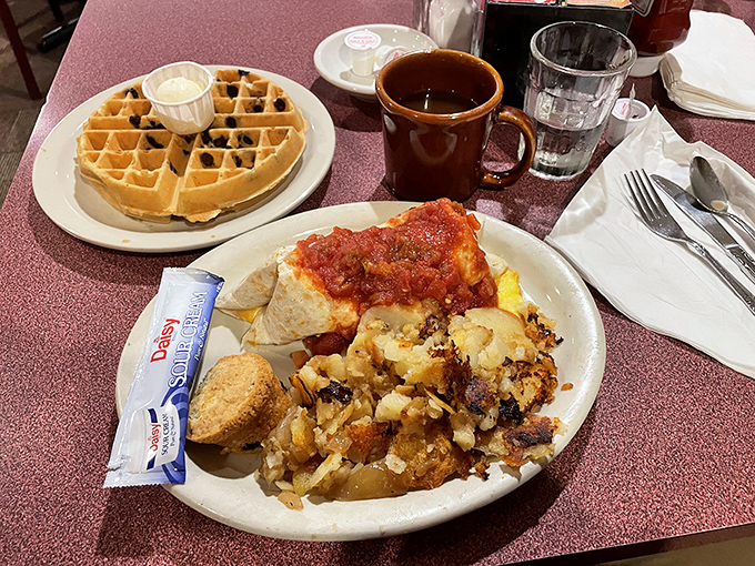 A breakfast spread that hits all the comfort food notes&mdash;homefries with perfect crispy edges, eggs, and a waffle that's clearly living its best life.