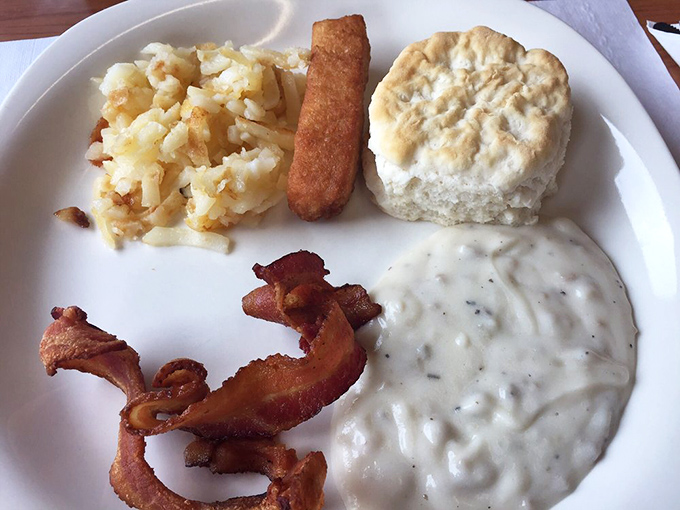 This isn't just breakfast&mdash;it's edible architecture. Crispy hash browns, flaky biscuit, thick-cut bacon, and gravy that could solve most of life's problems.