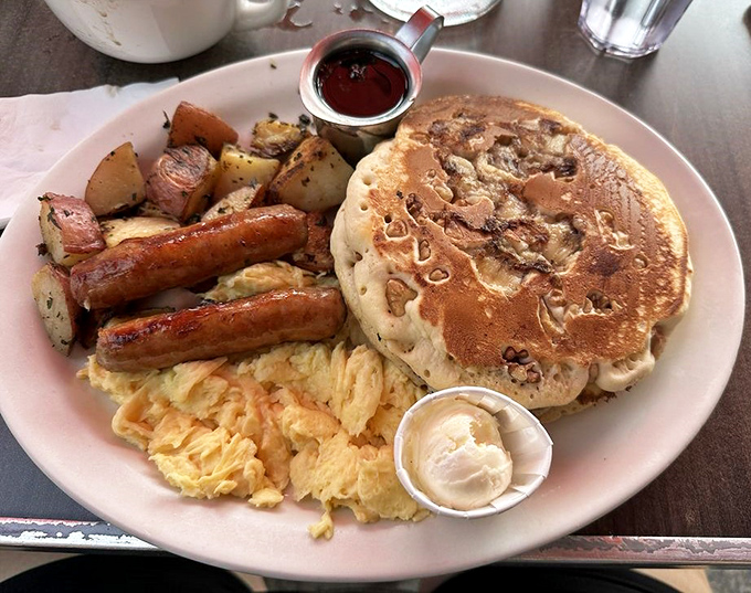 Pancakes that could double as edible frisbees, accompanied by the breakfast brigade of eggs, sausage, and crispy potatoes.