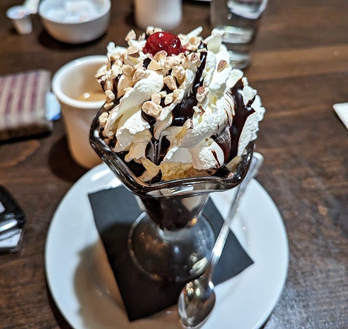 This hot fudge sundae isn't just dessert, it's architecture &ndash; a towering achievement of ice cream, whipped cream, and nuts that demands both respect and a spoon.