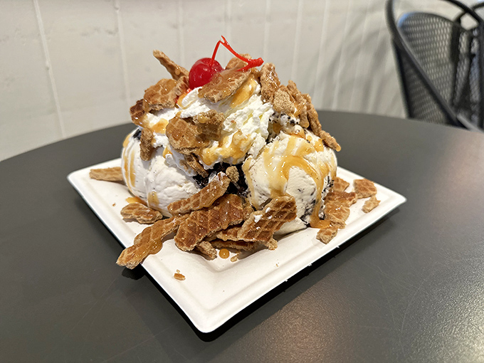 Architectural genius: ice cream balanced between crispy waffle shards, drizzled with caramel that cascades like a sugary waterfall.