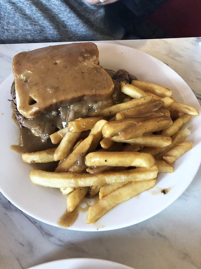 The hot roast beef sandwich&mdash;where gravy isn't just a topping but a philosophical approach to life. Fork required, napkins essential.