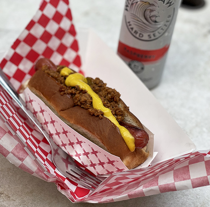 A classic dog with mustard and meat sauce—proof that simplicity, when done right, needs no apology. The checkered paper is practically a certificate of authenticity.