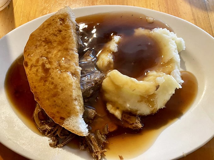 This isn't just a hot roast beef sandwich; it's a gravity-defying monument to gravy engineering that makes you want to write home immediately.