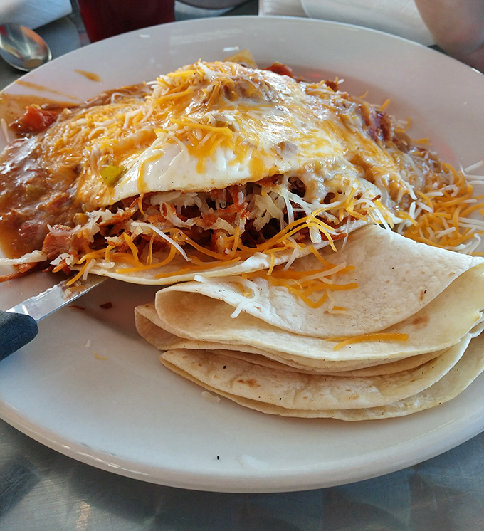 Layers of cheese, sauce, and tortillas create an edible architecture that would make Frank Lloyd Wright weep with joy. Huevos rancheros: breakfast with ambition.