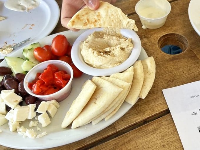 The Mediterranean platter arrives like a colorful United Nations of flavor&mdash;hummus, feta, and veggies playing together in perfect harmony. 