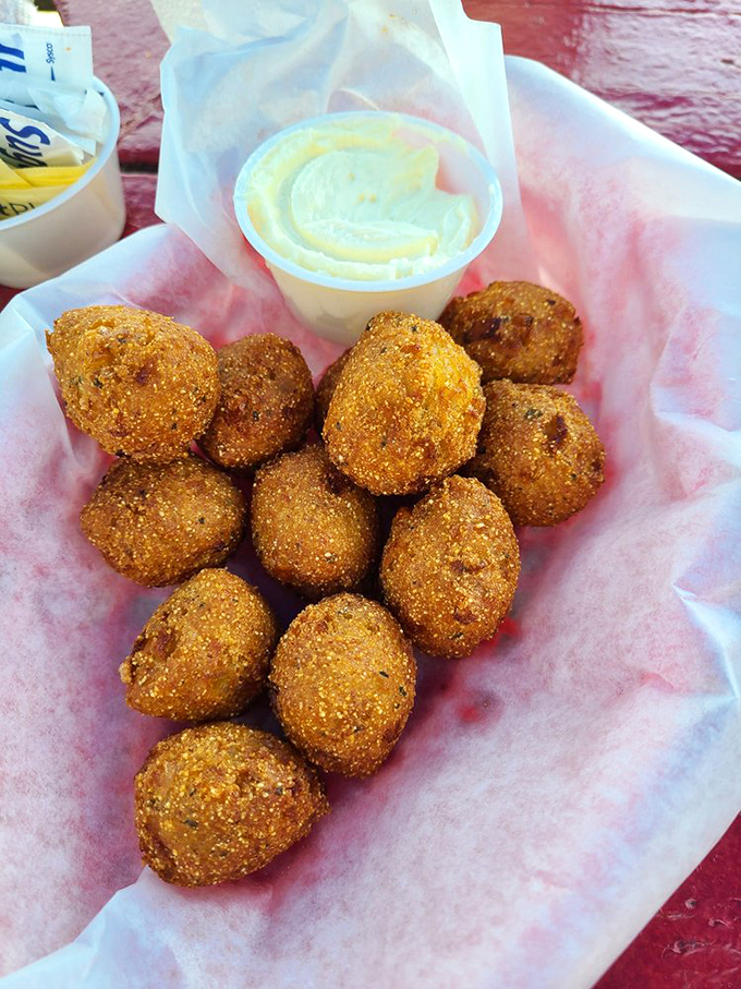 Golden-brown hush puppies huddle together like delicious little conspirators plotting to steal your diet plans.