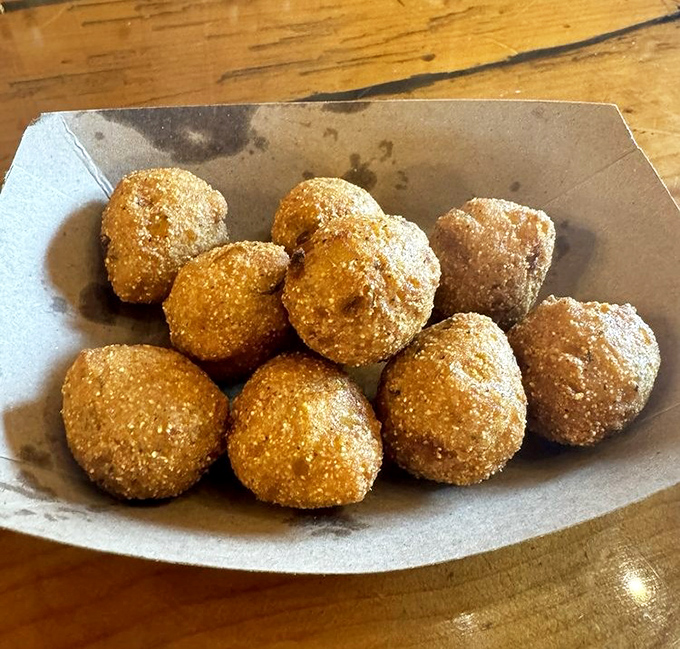 Hush puppies that would make a Southerner weep with joy. Golden, crispy orbs of cornmeal perfection that demand to be dunked.