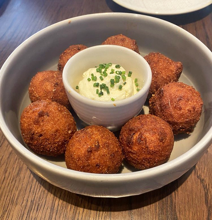 These Southern-style hush puppies aren't playing games &ndash; golden-brown spheres of happiness surrounding a creamy dip that demands to be savored.