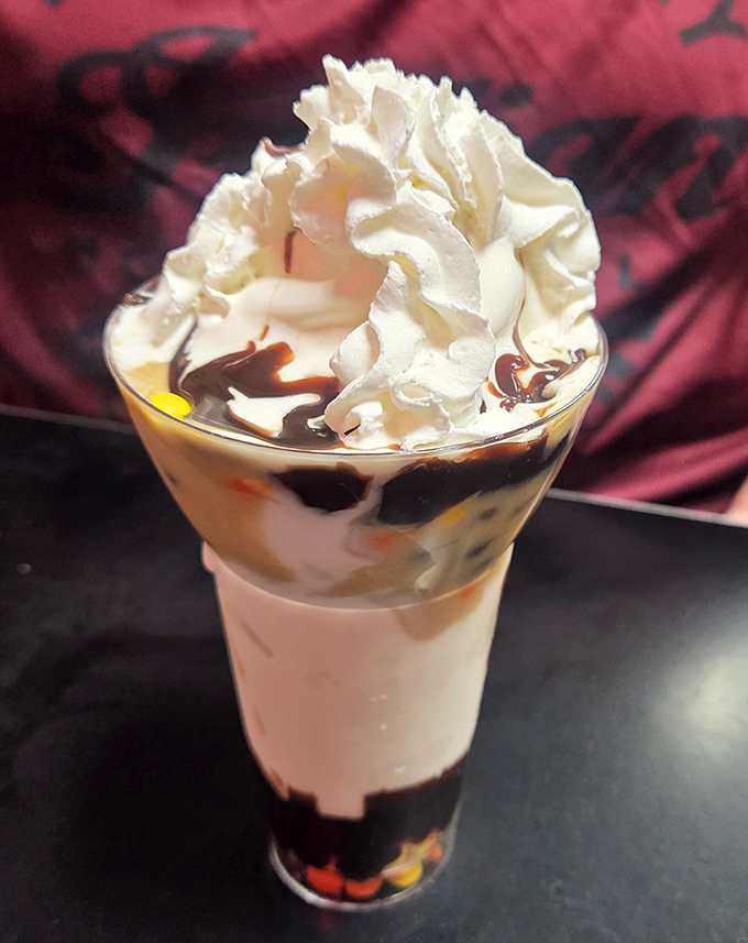 This isn't just a sundae—it's a structural engineering feat where whipped cream defies gravity while chocolate sauce plays by its own delicious rules.
