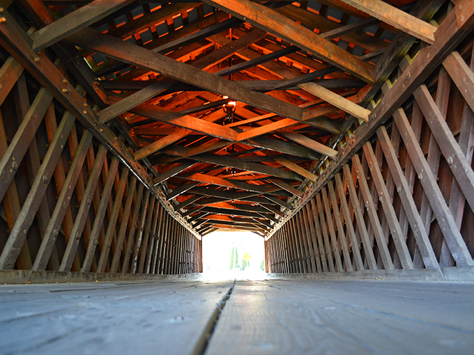 Looking down the bridge's interior is like peering through time's ribcage, each wooden beam telling stories of horse-drawn carriages and Model Ts.