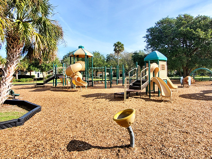 Palm trees stand sentinel over this playground where childhood happens the old-fashioned way: outdoors, unplugged, and sand-free.