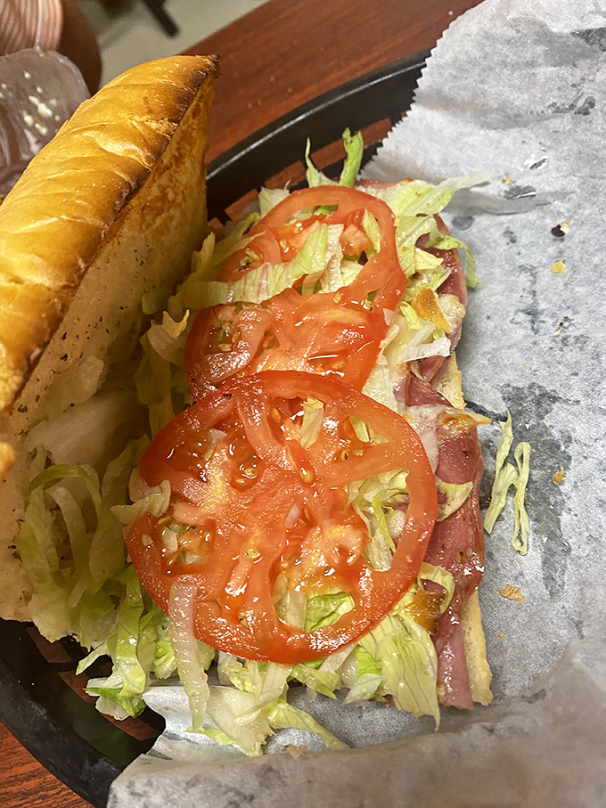 This isn't just a sandwich; it's an Italian hoagie architectural marvel with layers of meat, cheese, and veggies that requires both hands and napkins.