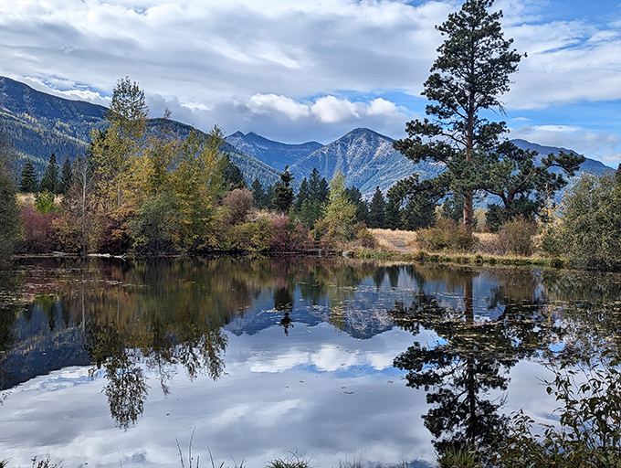 Mirror-perfect reflections that make you question which way is up. This peaceful pond captures mountains twice their actual size.