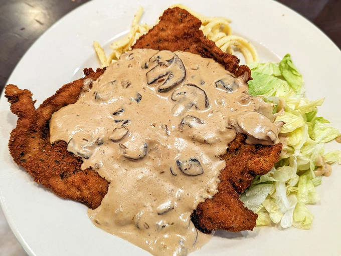 This Jaeger Schnitzel doesn't just come with mushroom sauce, it arrives swimming in a creamy forest of fungal perfection atop tender sp&auml;tzle.