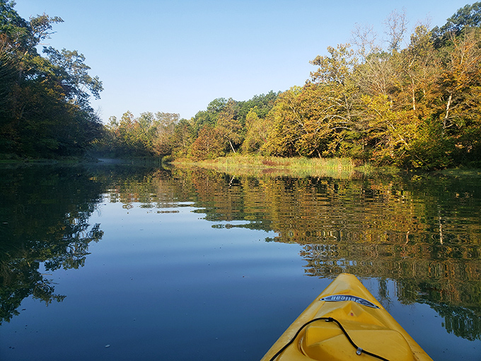 Paddling through autumn's reflection &ndash; kayaking Spring Mill Lake feels like gliding through a living Impressionist painting.