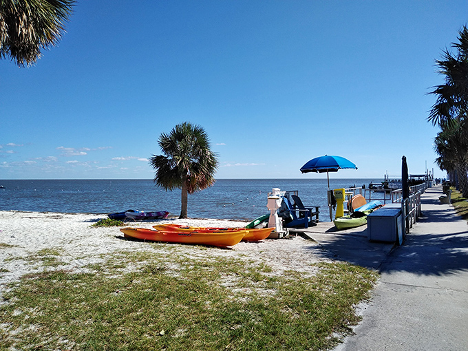 Beach simplicity at its finest &ndash; a yellow kayak waiting patiently for adventure while palm trees stand guard over the gentle Gulf waters.