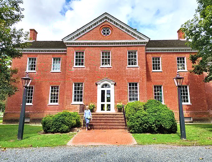 Ker Place stands as stately as a Southern gentleman in a seersucker suit, its brick facade and symmetrical windows exuding timeless elegance.