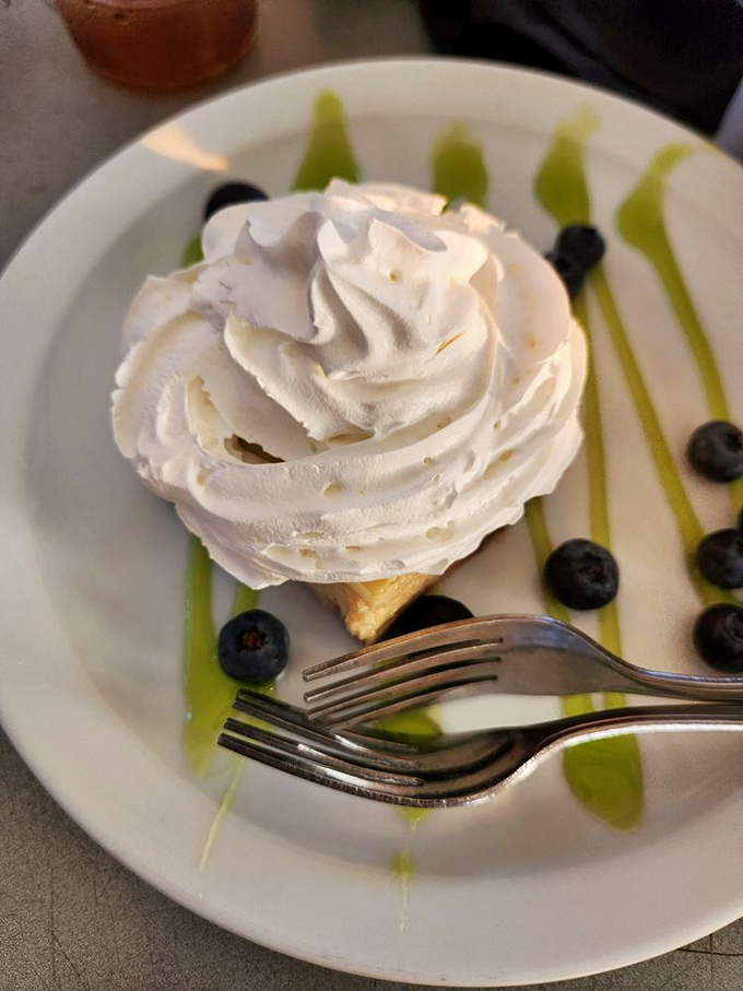 This key lime pie arrives with more whipped cream than a Broadway musical and twice as much Florida sunshine.