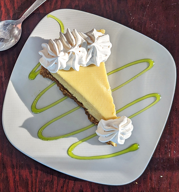 The key lime pie arrives like a yellow sunbeam on a plate, with artistic lime sauce that says, "Yes, we're serious about dessert."