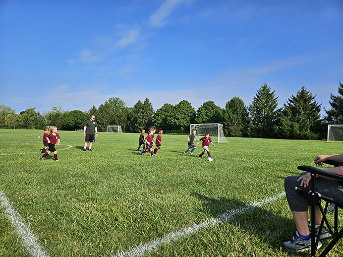 Kyle Park offers family-friendly recreation where children's laughter mingles with rustling leaves overhead.