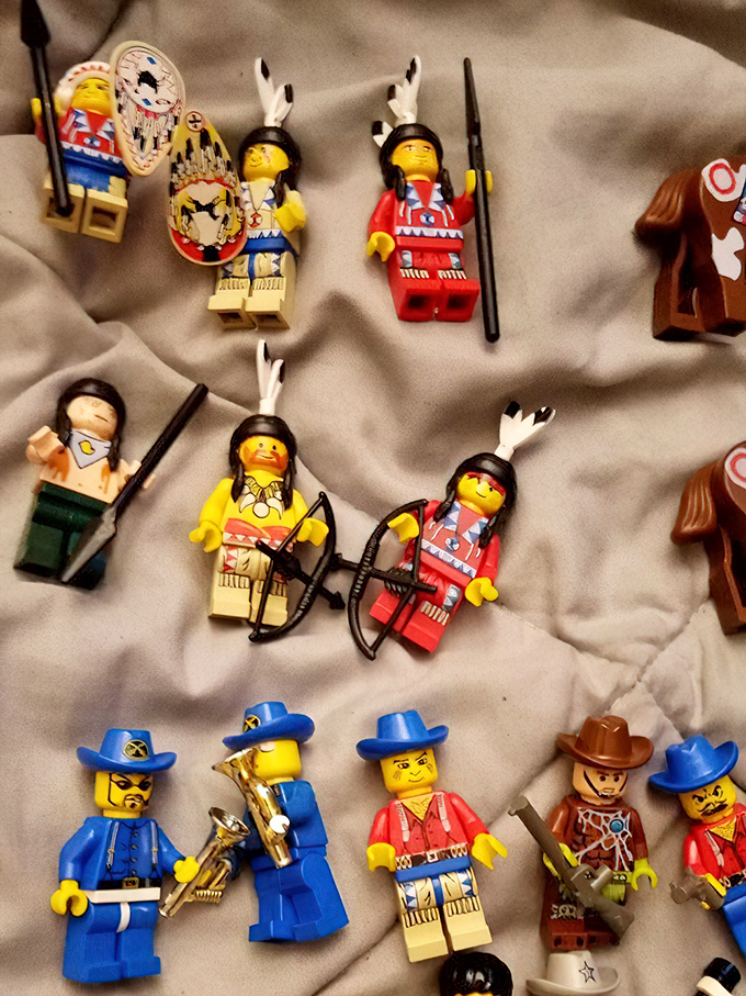 Tiny plastic cowboys and Native American figures stand at attention, ready to join collections or spark imaginative adventures.