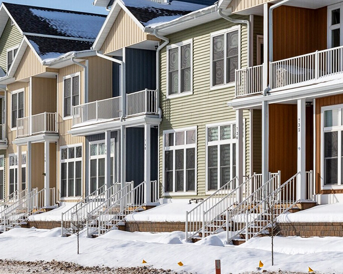 Modern lakefront living meets Upper Peninsula practicality in these colorful townhomes, where residents wake to Lake Superior's ever-changing moods.