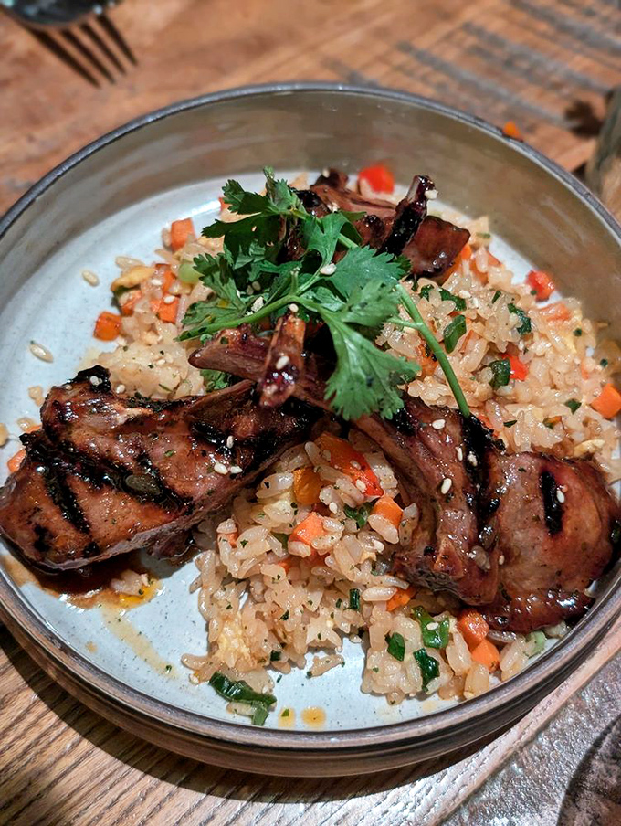 Lamb chops nestled on a bed of fragrant rice. The kind of dish that makes you close your eyes on the first bite and forget you're in public.