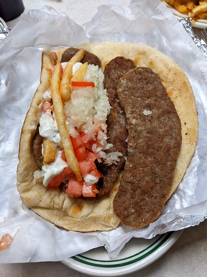 Culinary innovation meets street food tradition. This loaded creation proves that sometimes the best dining experiences come wrapped in paper.