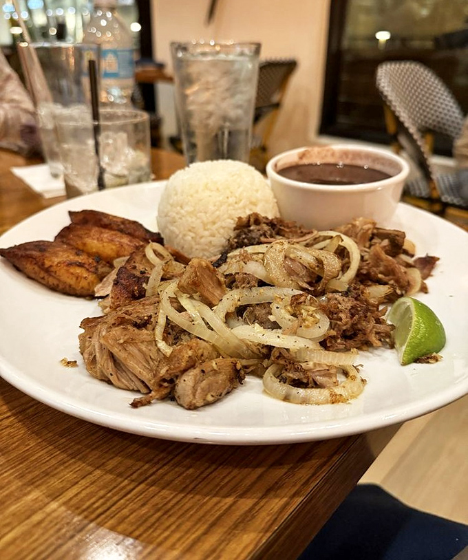 Lechón asado that would make your abuela weep with joy—tender pork with caramelized edges alongside plantains that taste like candy for grown-ups.
