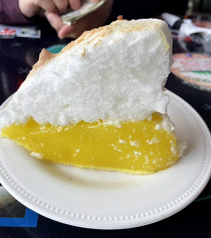 Lemon meringue pie that defies gravity&mdash;cloud-like meringue floating above sunshine-yellow filling. This isn't dessert; it's edible optimism on a plate.