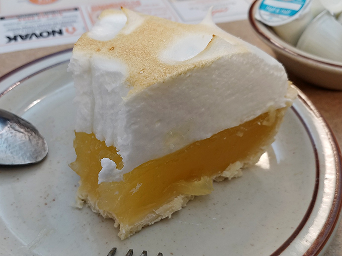 Lemon meringue pie so tall it needs its own zip code, with a cloud of meringue that's somehow both substantial and lighter than your post-dessert promises to exercise.