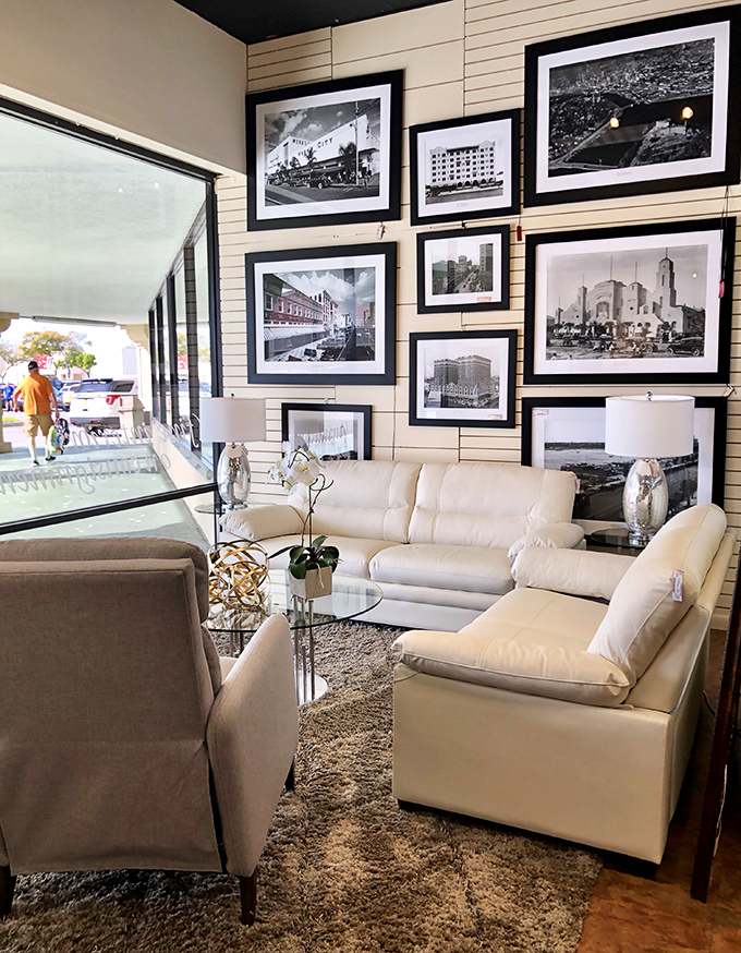 A gallery wall of black and white photographs creates the perfect backdrop for this elegant cream leather seating arrangement.