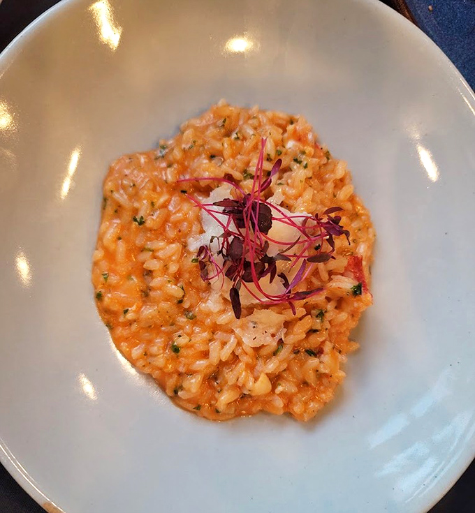 This lobster risotto isn't just a dish&mdash;it's a sunset-colored canvas of creamy perfection topped with delicate microgreens. Comfort food dressed for the opera.