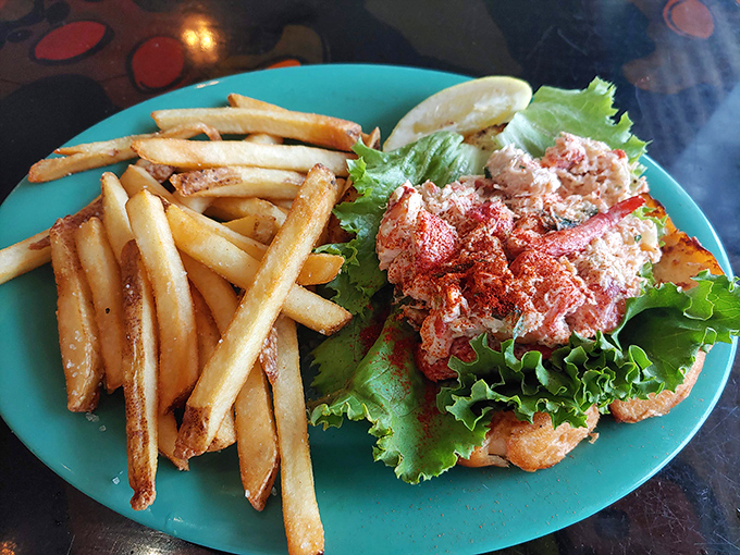 A proper lobster roll doesn't need to show off. This beauty, nestled on crisp lettuce with golden fries standing guard, speaks for itself.