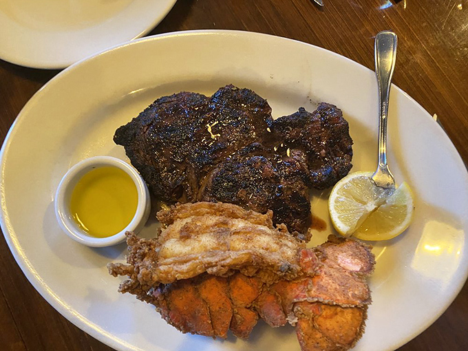 A surf and turf affair that doesn't need to shout &ndash; perfectly seared steak alongside golden-fried lobster tail, proving simplicity is the ultimate sophistication.