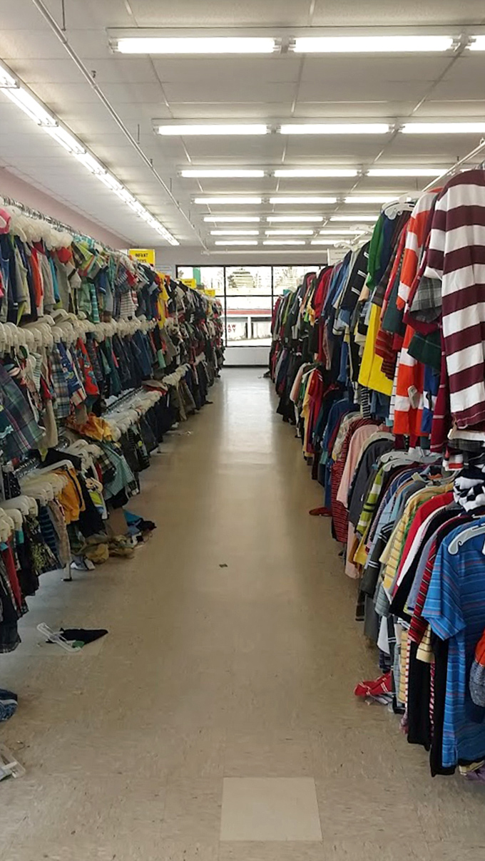 The clothing aisles create a textile canyon where shoppers navigate between walls of potential wardrobe transformations.