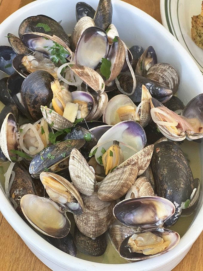 These steamed mussels and clams aren't just seafood&mdash;they're a briny symphony in a bowl, each shell opening to reveal a perfect morsel of ocean treasure.
