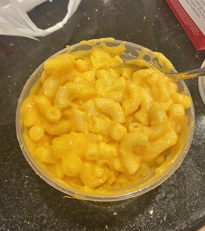 Mac and cheese that glows with the kind of artificial yellow that somehow signals authentic comfort food. Nostalgic, gooey, and unapologetically simple.