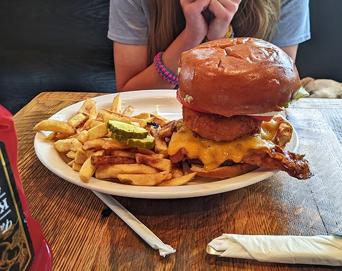 This isn't just a burger—it's an architectural achievement. The bacon-topped behemoth requires both hands, napkins, and possibly a nap afterward.