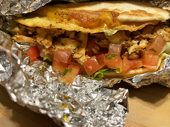 Peek inside this foil-wrapped wonder and discover a perfect harmony of seasoned fish, fresh tomatoes, and that mysteriously addictive sauce.