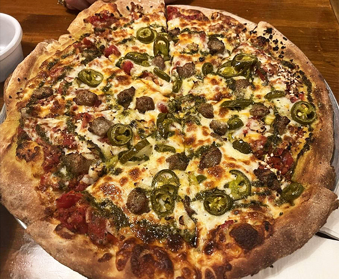 This isn't just pizza; it's a circular masterpiece where jalape&ntilde;os and sausage perform a spicy tango atop a perfectly charred crust.