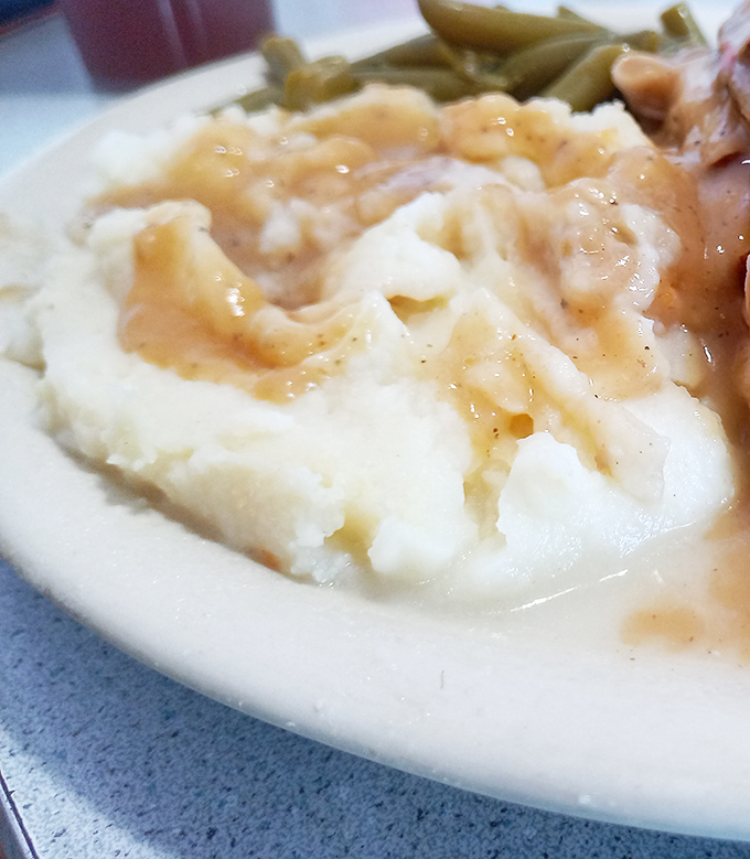 These mashed potatoes aren't just a side dish &ndash; they're a cloud-like vessel for rivers of homestyle gravy that demands to be savored.