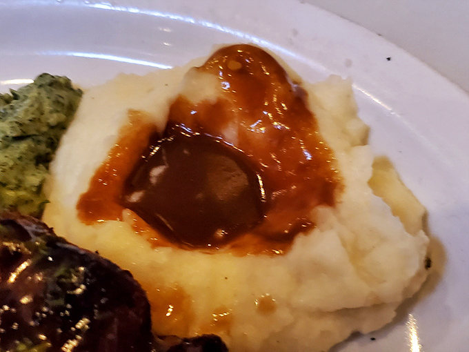 Those mashed potatoes aren't just a side dish &ndash; they're a gravy-filled crater of comfort waiting to complement each bite of perfectly cooked beef.