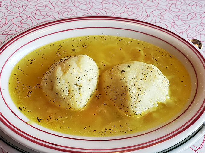 The famous matzo ball soup&mdash;where fluffy dumplings float like edible clouds in a golden broth that grandmothers everywhere would approve of.