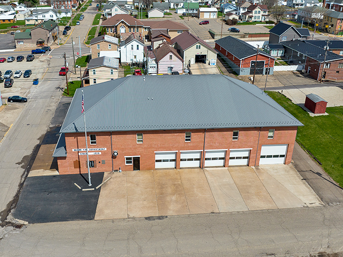 The McConnelsville Fire Department stands ready to serve, a brick testament to small-town security where volunteer firefighters are local heroes.