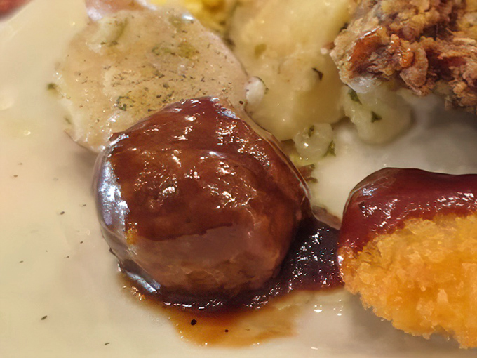 That meatball isn't just swimming in gravy—it's doing the backstroke in flavor country. Comfort food Olympics, gold medal contender.