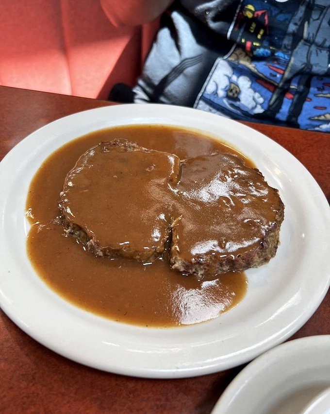 Meatloaf swimming in a lake of savory gravy. Grandma would be jealous of this hearty slice of Americana done right.